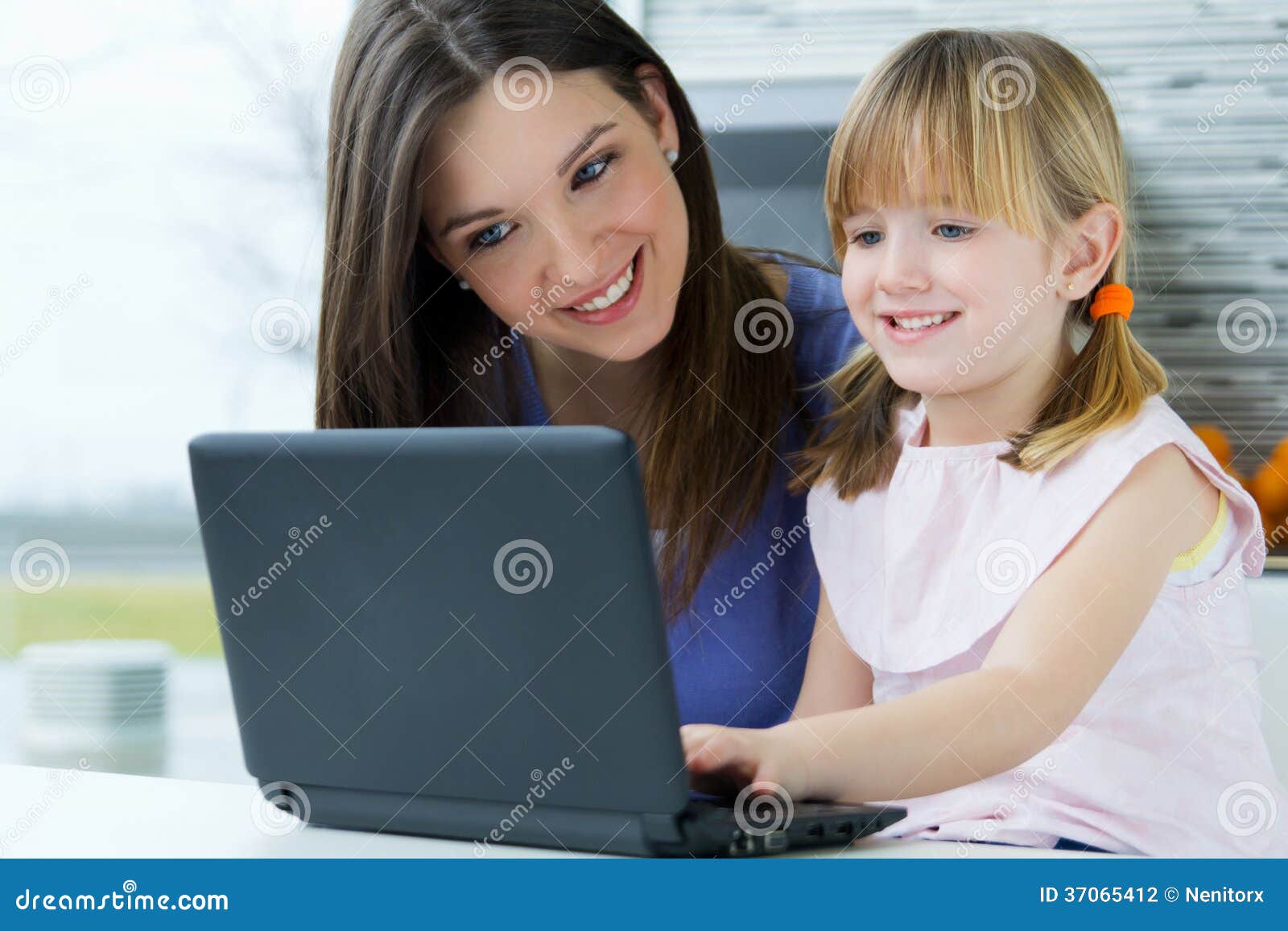 Mother and Daughter Using Laptop in the Kitchen Stock Photo - Image of ...