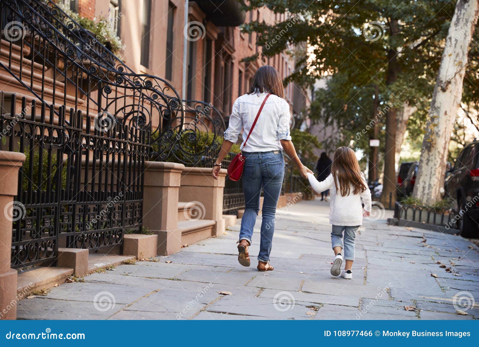 Mother and Daughter Walking Down the Street, Back View Stock Photo ...