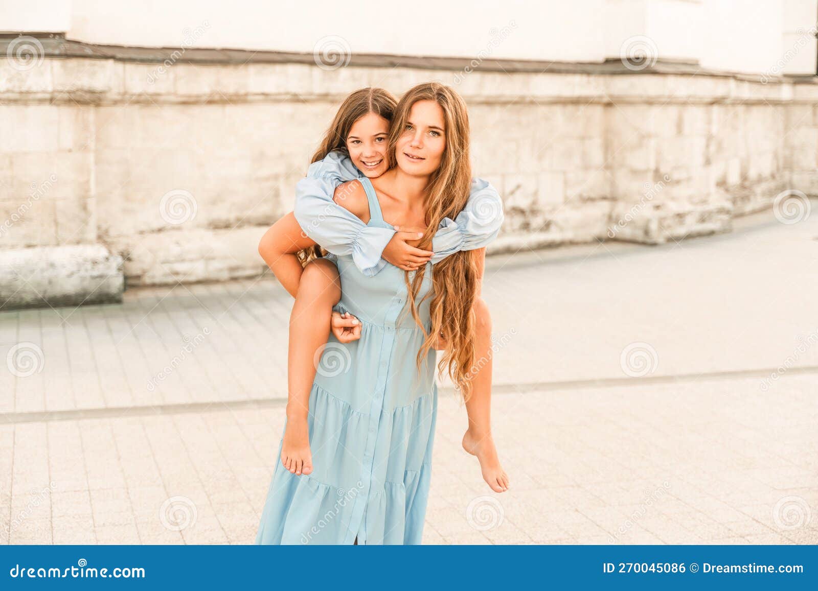 Mother Of The Daughter Walks Playing Mother Holds The Girl On Her Back