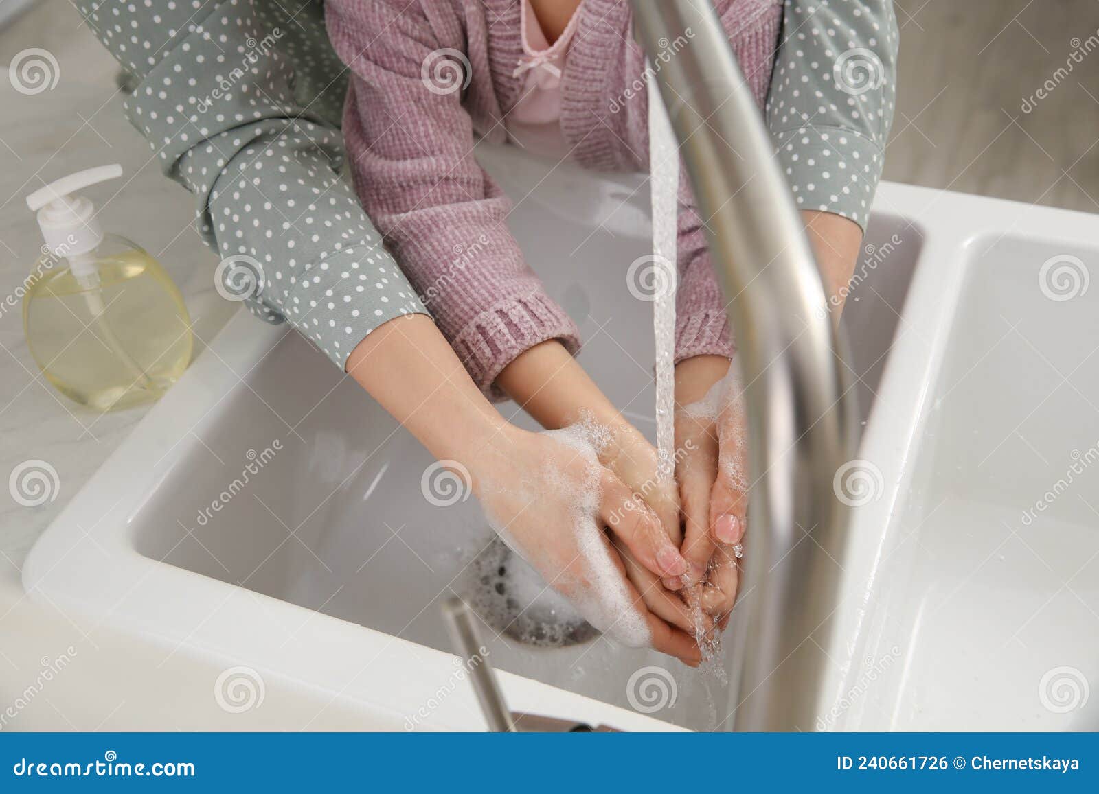 Mother and Daughter Washing Hands with Liquid Soap Together at Home ... Mother and Daughter Washing Hands with Liquid Soap Together at Home ...
