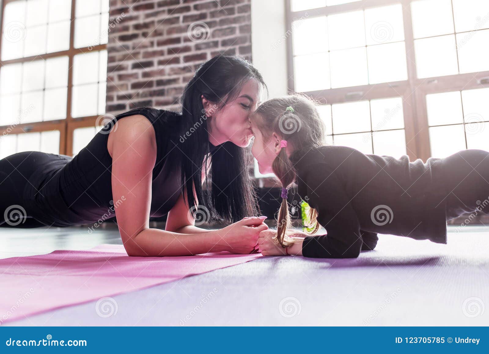 Mother and Daughter Working Out Together Doing Plank Exercise Stock ...