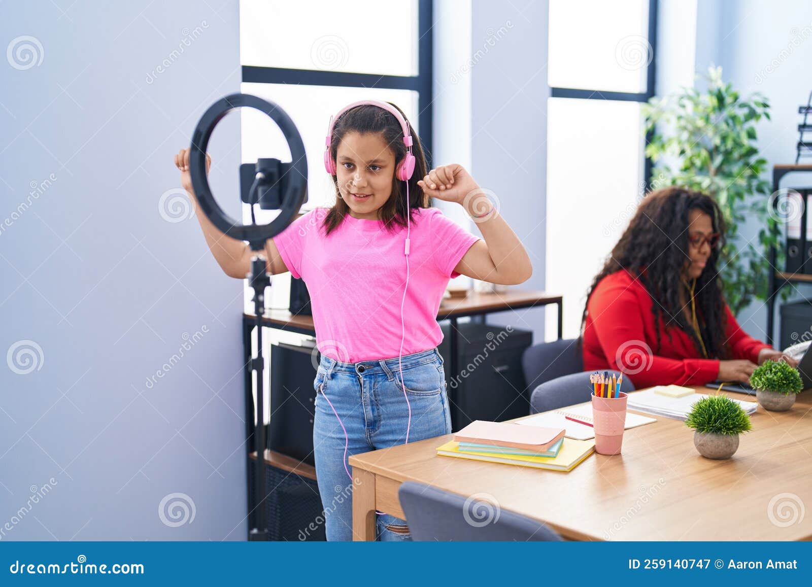 Mother and Daughter Working and Recording Dance Video at Office Stock ...