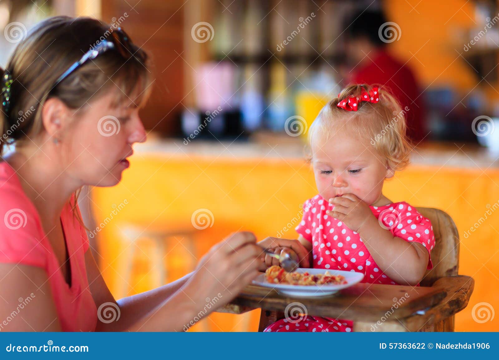 Mother Feeding Infant Daughter in Cafe Stock Photo - Image of girl ...