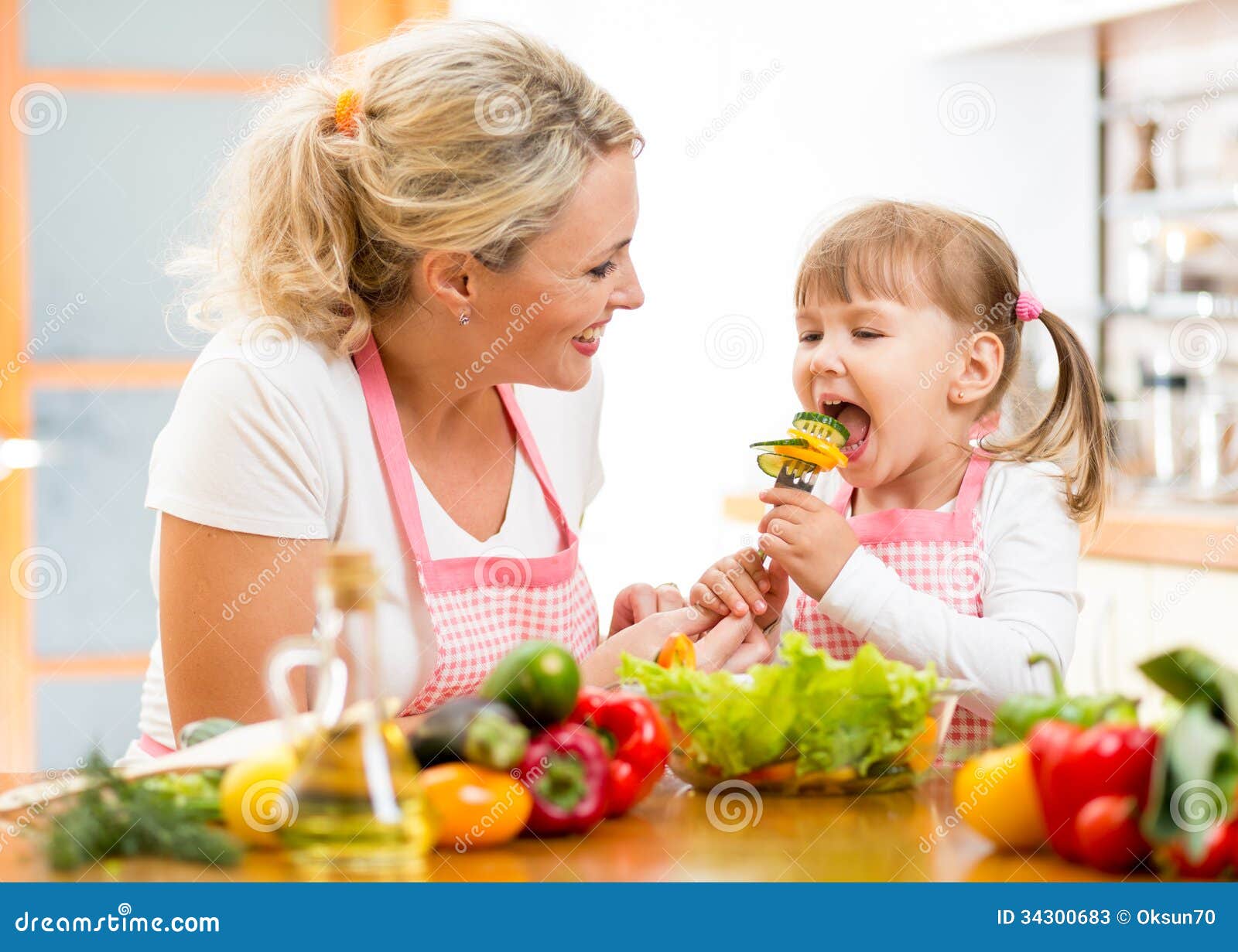 Mother Feeding Kid Vegetables in Kitchen Stock Image - Image of fresh ...