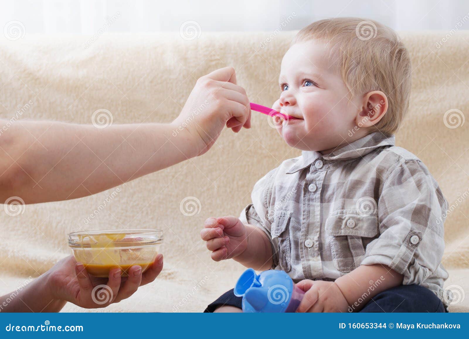Mother Feeds Small Child with Fruit Puree Stock Photo - Image of food ...