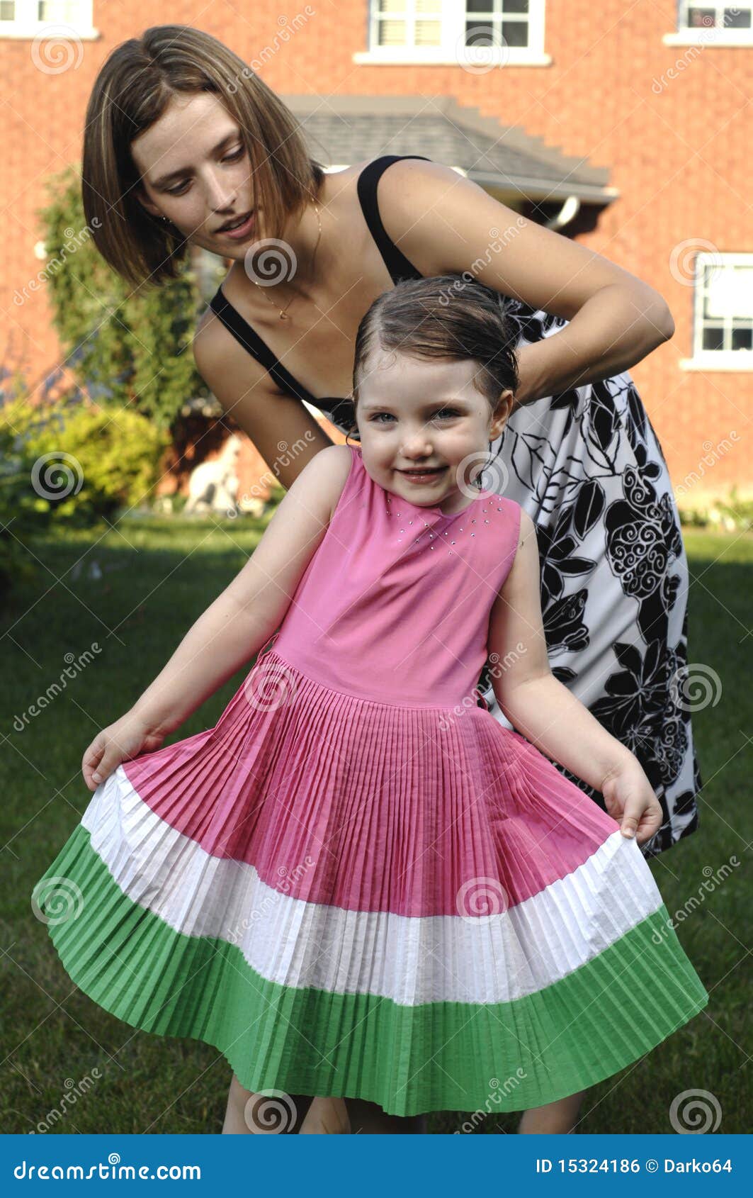Mother Fixing Daughter S Hair Stock Photo - Image of male, flower: 15324186