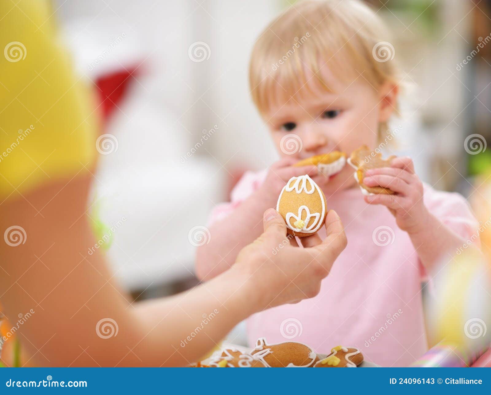 Mother Giving Baby Cookie in Shape of Easter Egg. Stock Image - Image ...