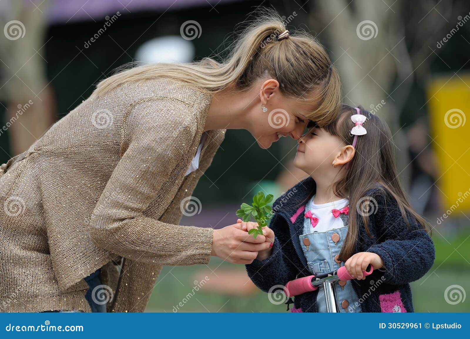 Mother Giving Daughter Ride on Back in Park. Stock Image - Image of ...