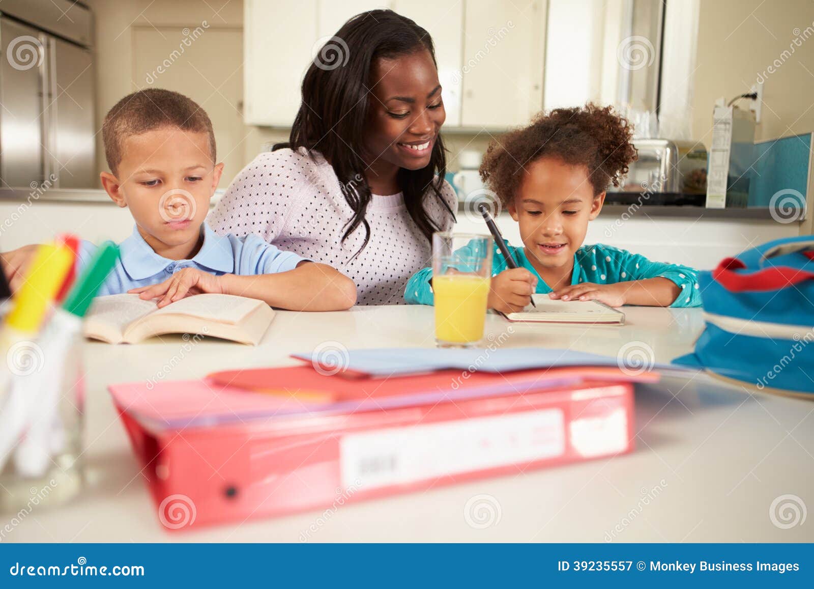 Mother Helping Children with Homework at Table Stock Image - Image of ...