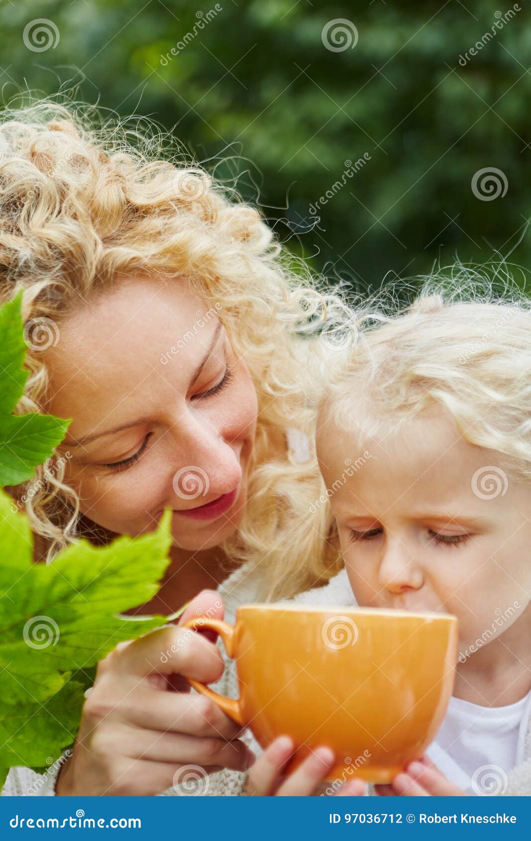 Mother Helping Daugther Drink Tea Stock Photo - Image of girl ...