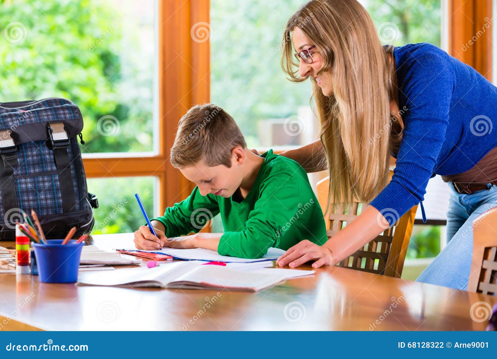 Mother Helping with School Homework Assignment Stock Photo - Image of ...