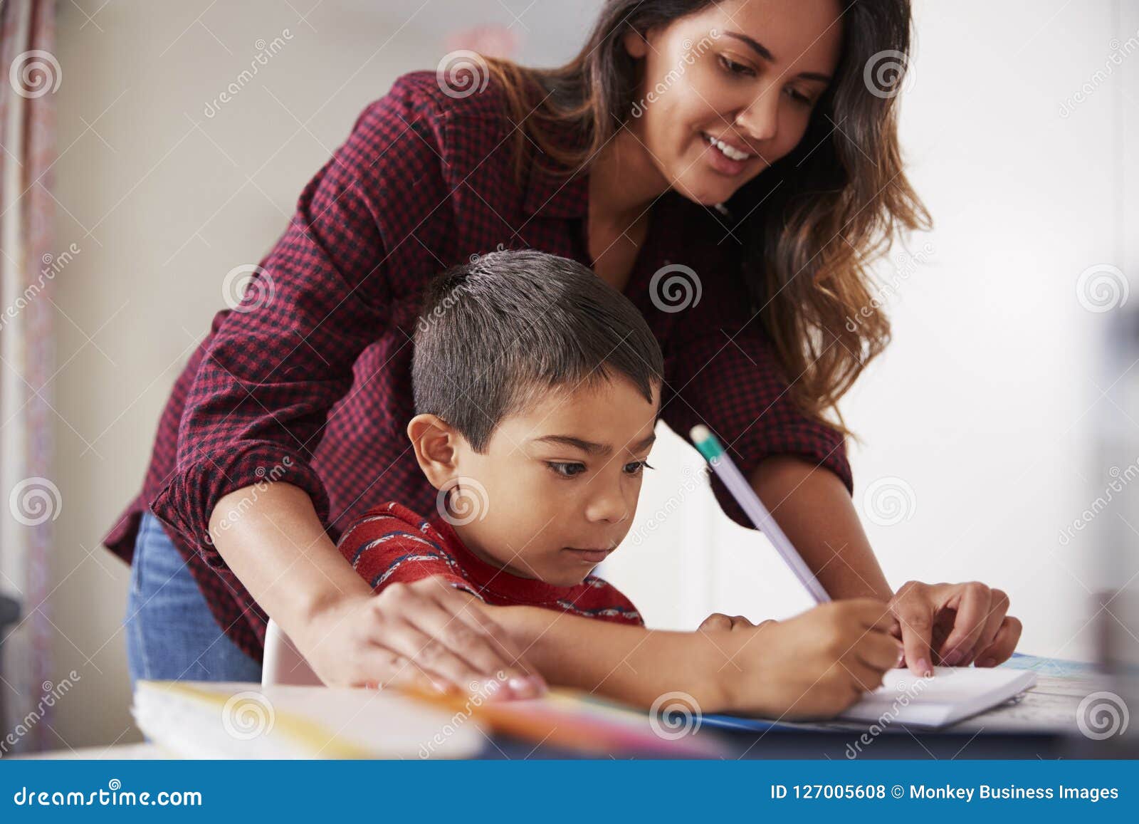 Mother Helping Son with Homework Sitting at Desk in Bedroom Stock Photo ... Mother Helping Son with Homework Sitting at Desk in Bedroom Stock Photo ...