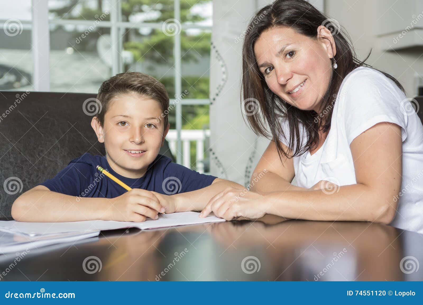 Mother Helping Son with Homework at Table Stock Photo - Image of family ...