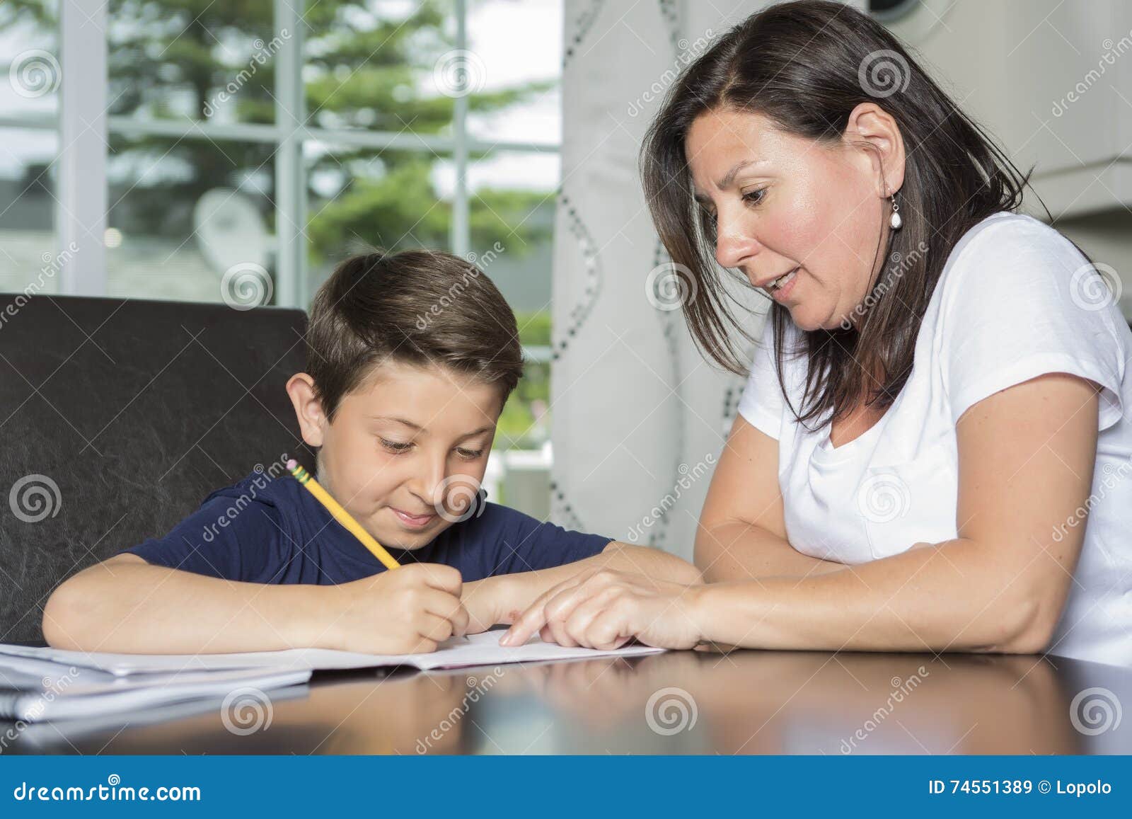 Mother Helping Son with Homework at Table Stock Image - Image of women ...