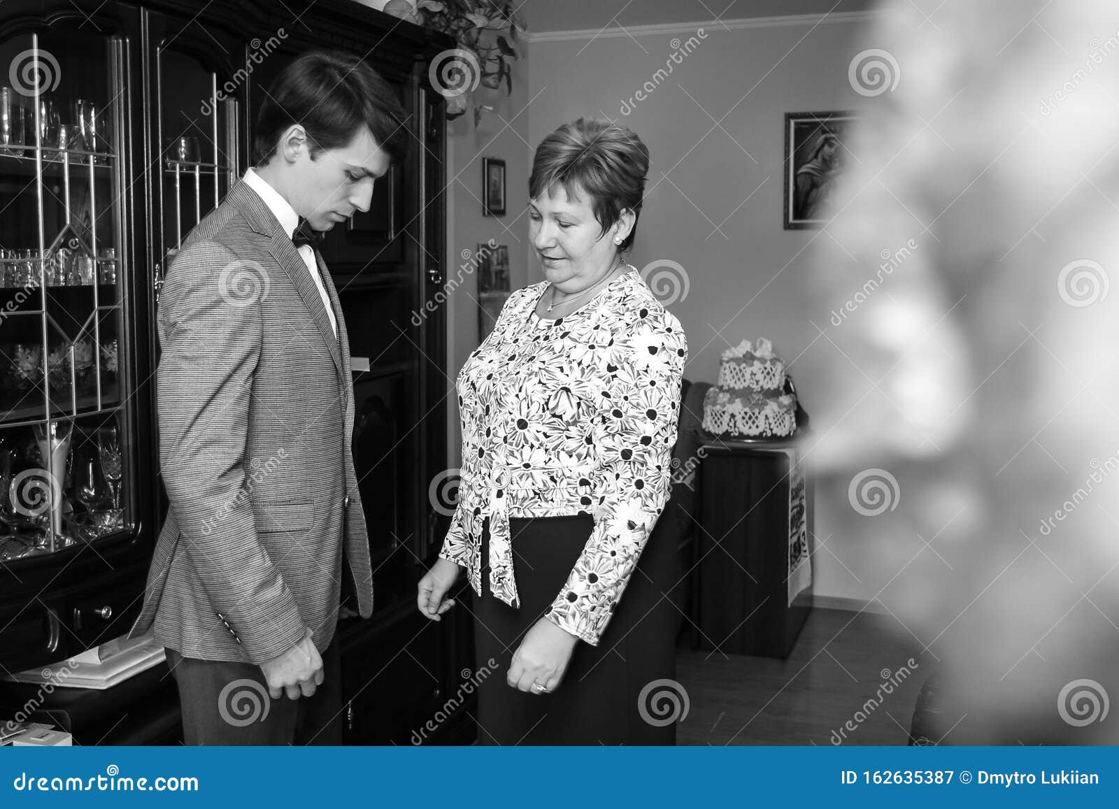 Mom Helps Her Son and Groom Get Dressed in a Wedding Suit. Groom and ... Mom Helps Her Son and Groom Get Dressed in a Wedding Suit. Groom and ...