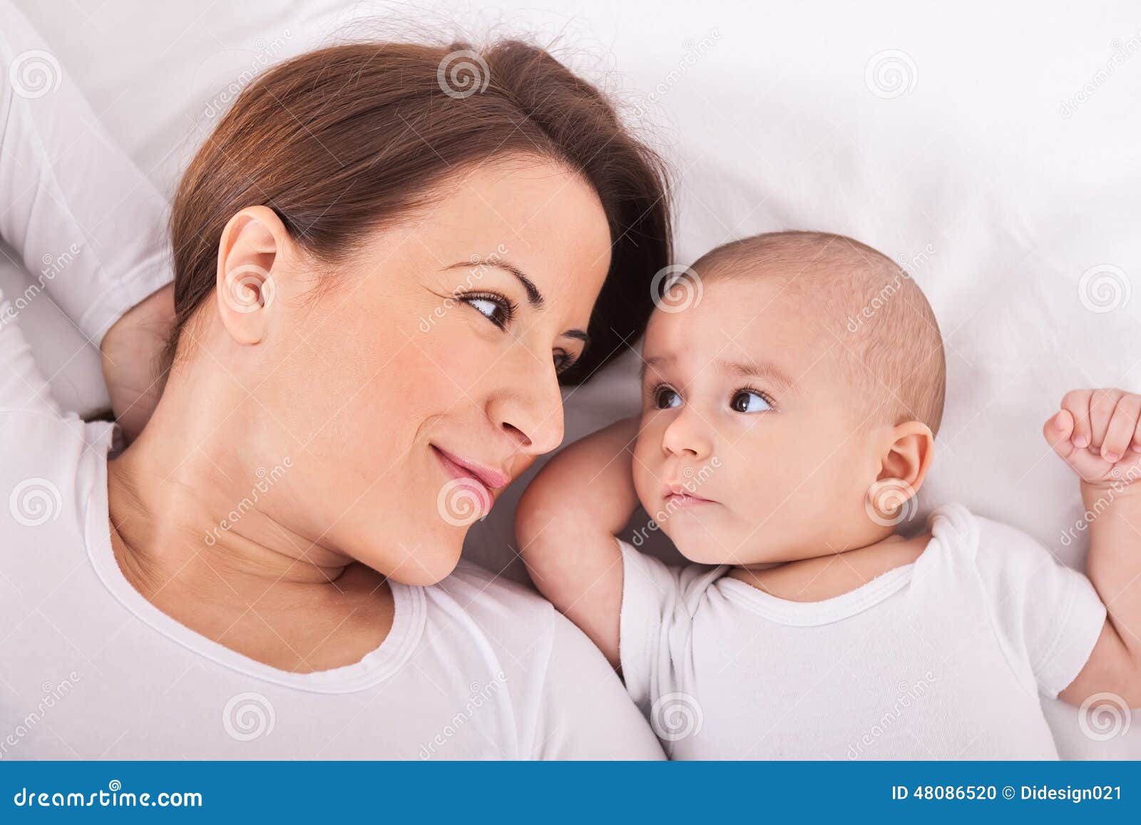 Mother with Her Baby Relaxing on Bed Stock Photo - Image of babies ...