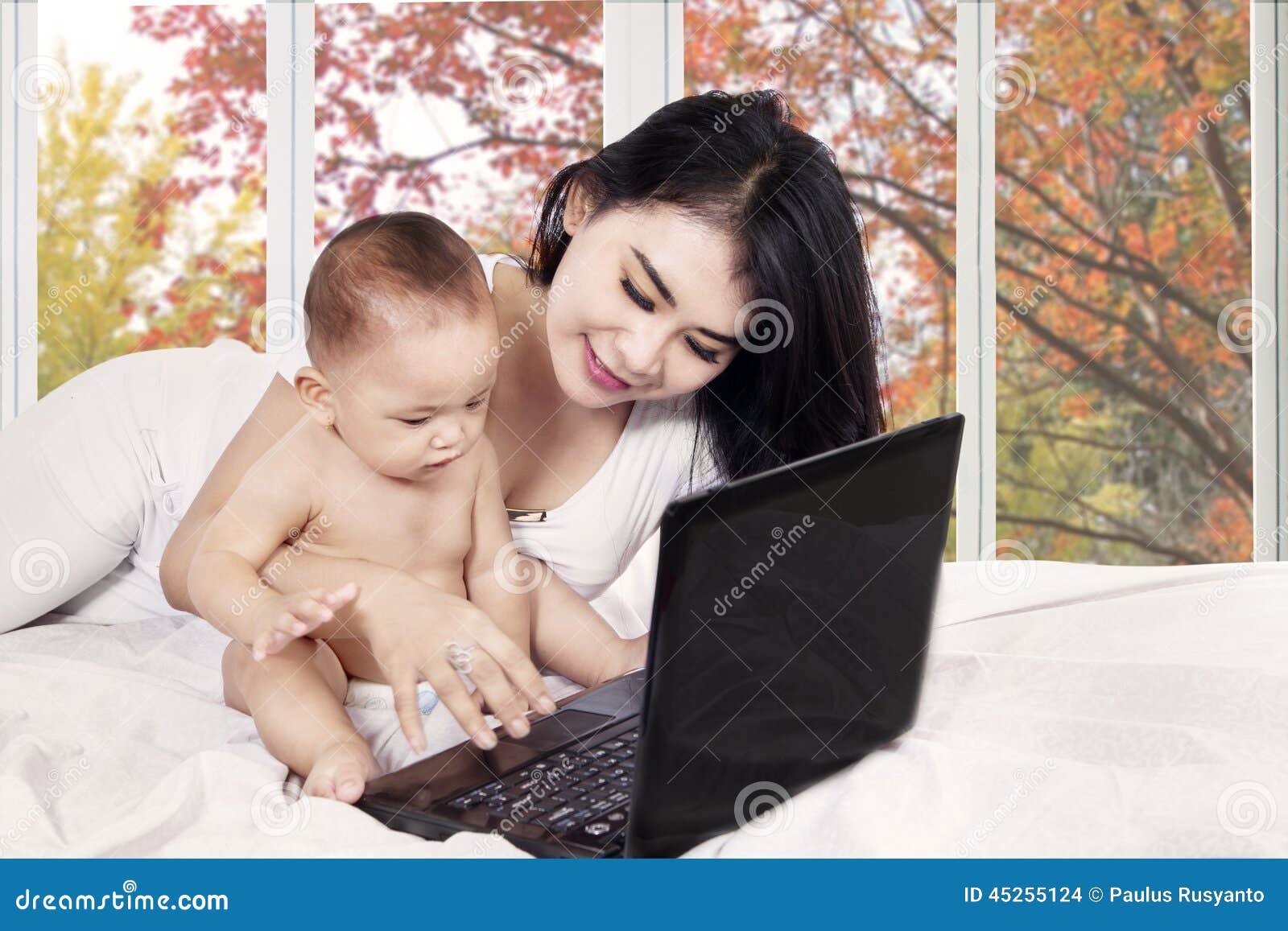 Mother and Her Baby Using Laptop Stock Photo - Image of daughter ...