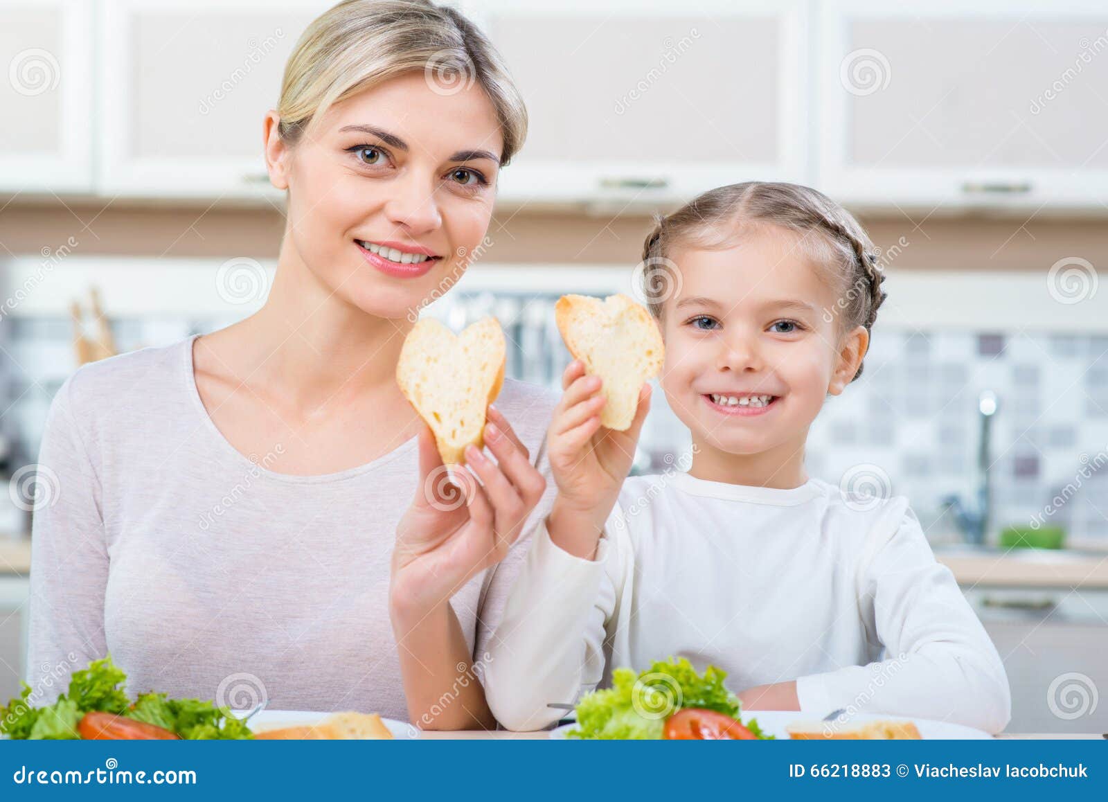 Mother And Her Daughter Eating In The Kitchen Stock Image Image Of