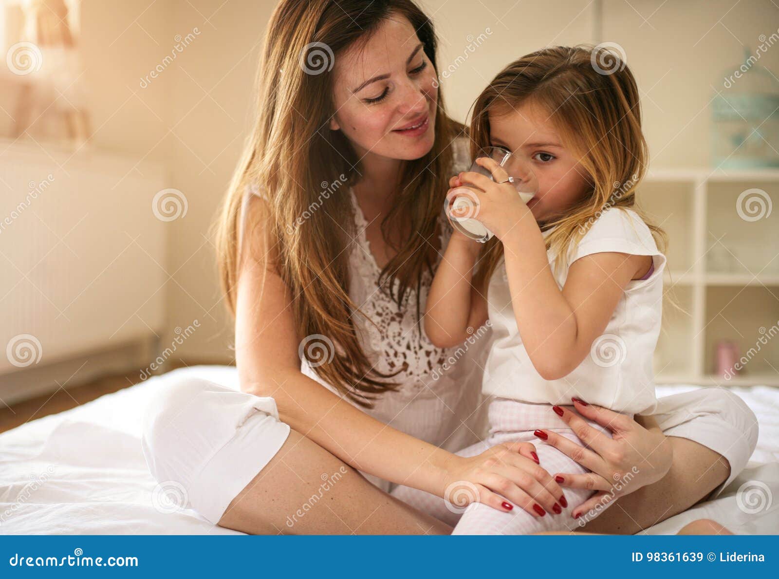Mother With Her Daughter Enjoying In Bed Together Stock Image Image