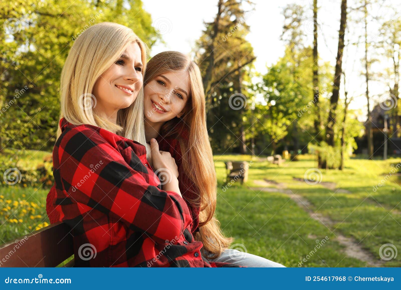 Mother With Her Daughter Spending Time Together In Park On Sunny Day