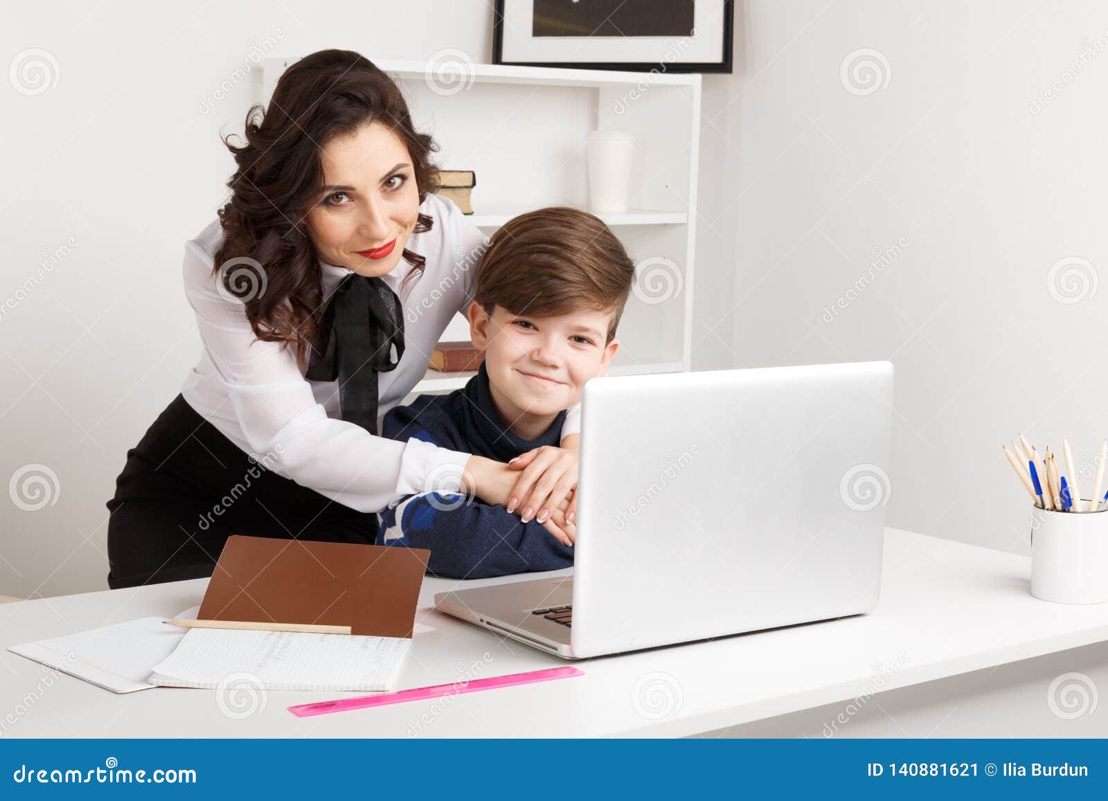 Mother and Her Son Doing Homework in the White Room. Typing Homework on ...