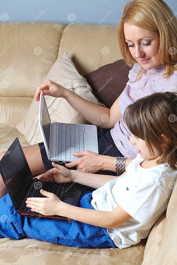 Mother with Her Son Work on Two Netbook Computers Stock Image - Image ...