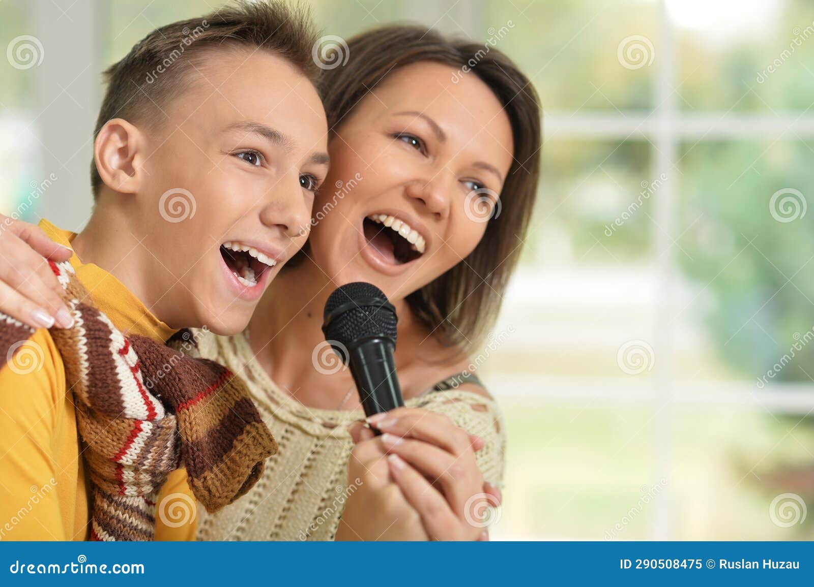 Mother and His Son Singing into the Microphone. Stock Image - Image of ...
