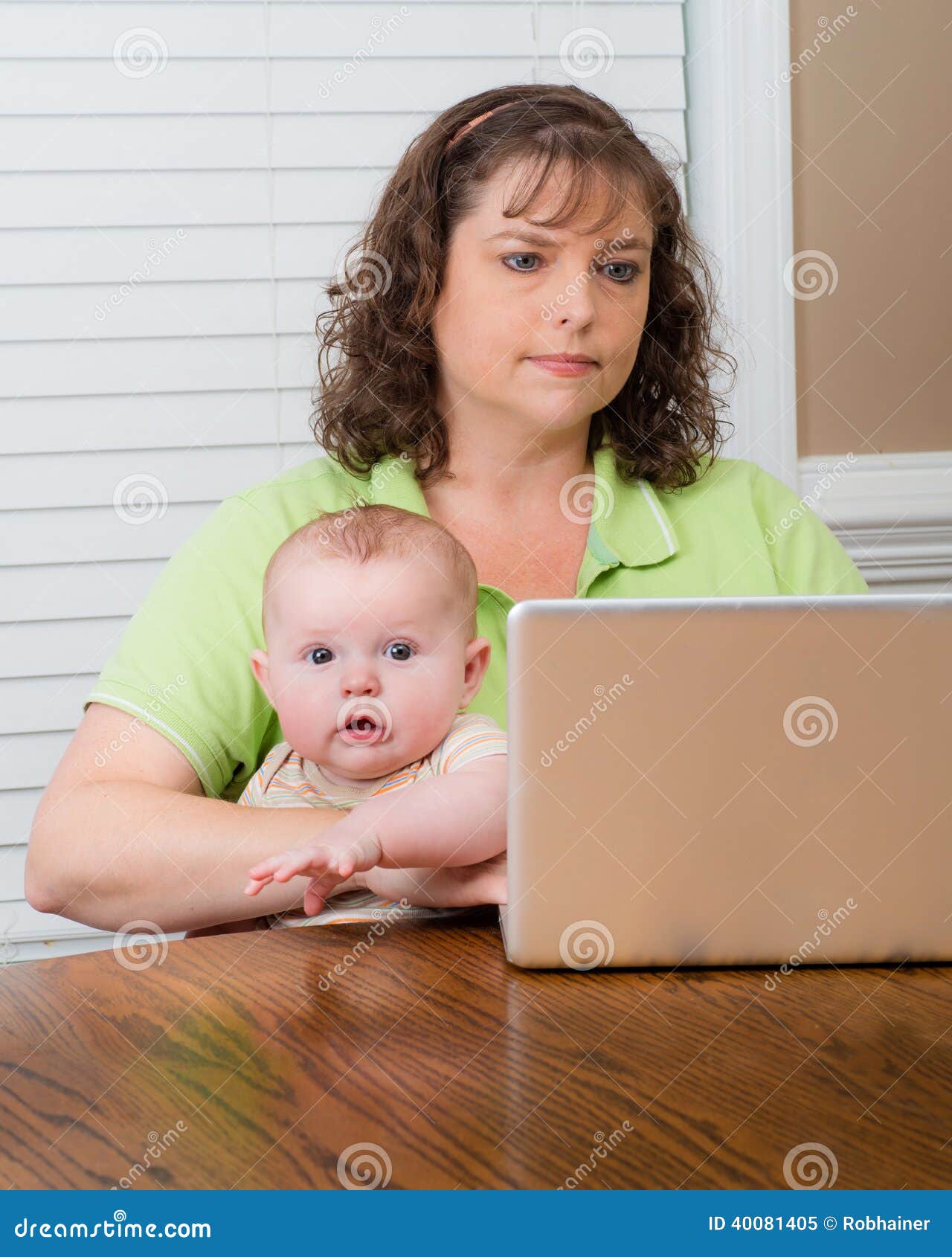 Mother Holding Baby while Working on Computer Stock Image - Image of ...