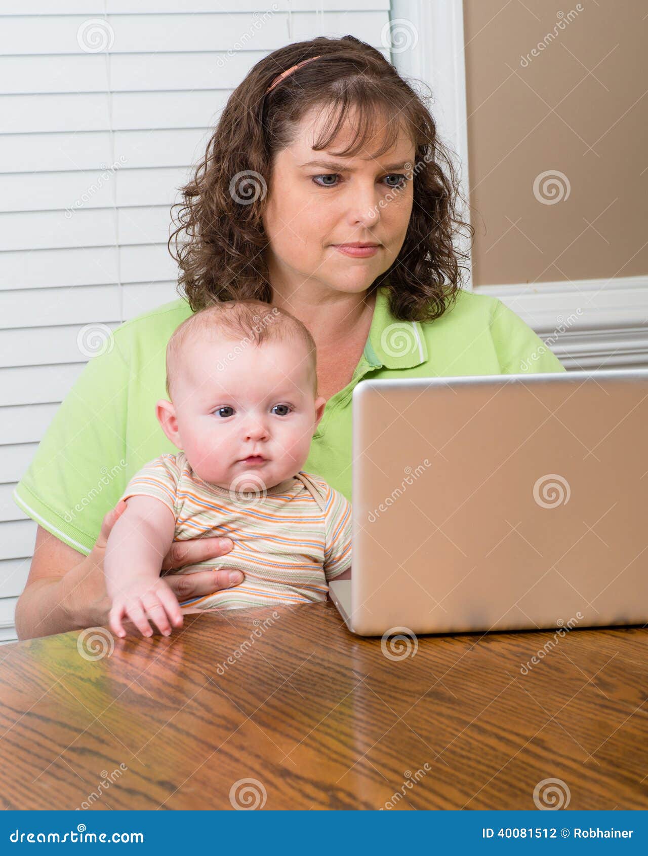 Mother Holding Baby while Working on Computer Stock Photo - Image of ...