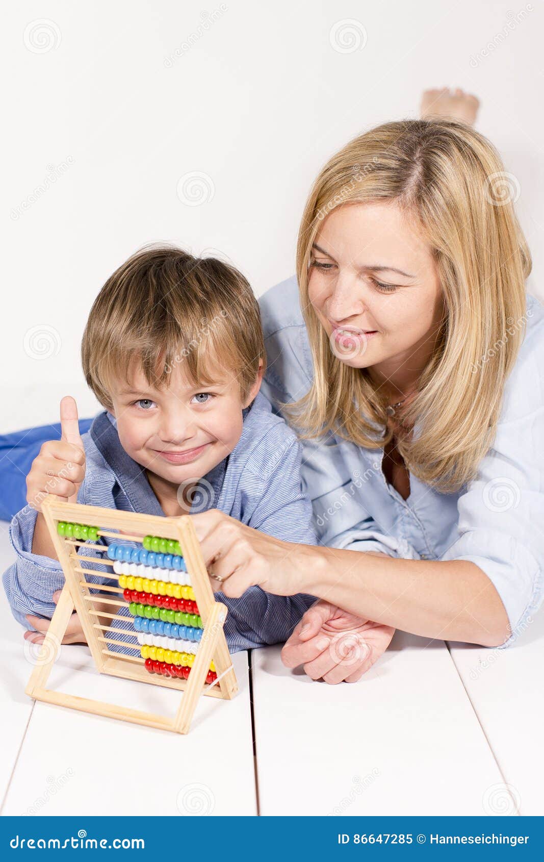 Mother Learns To Calculate with Son on a White Floor Stock Image ...