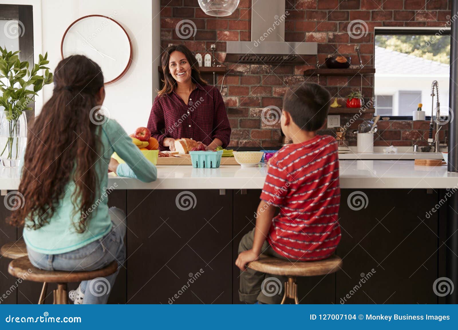 Mother Making School Lunches for Children in Kitchen at Home Stock ...