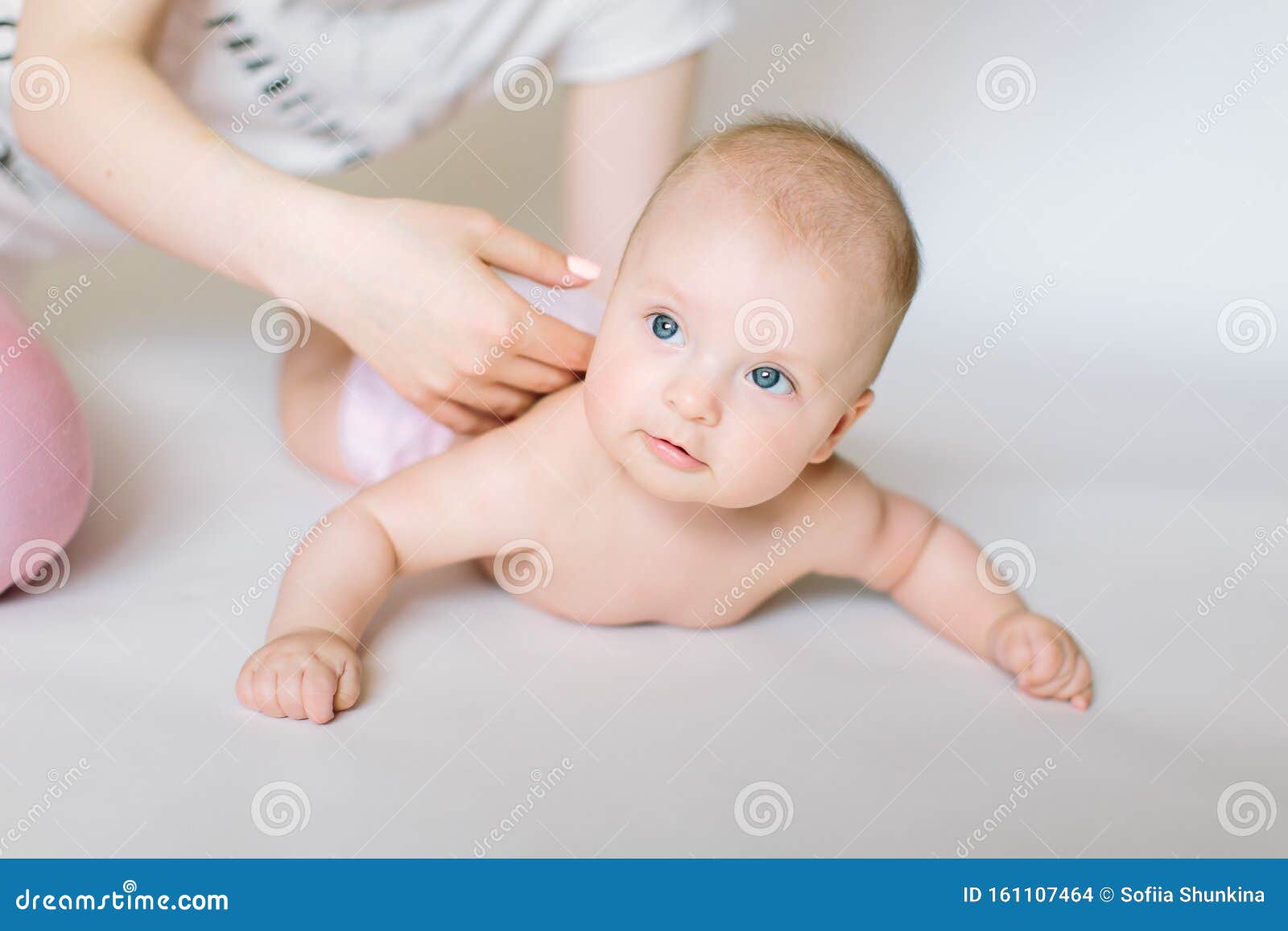 Mother Massaging and Exercise Her Little Baby Back Stock Photo - Image ...