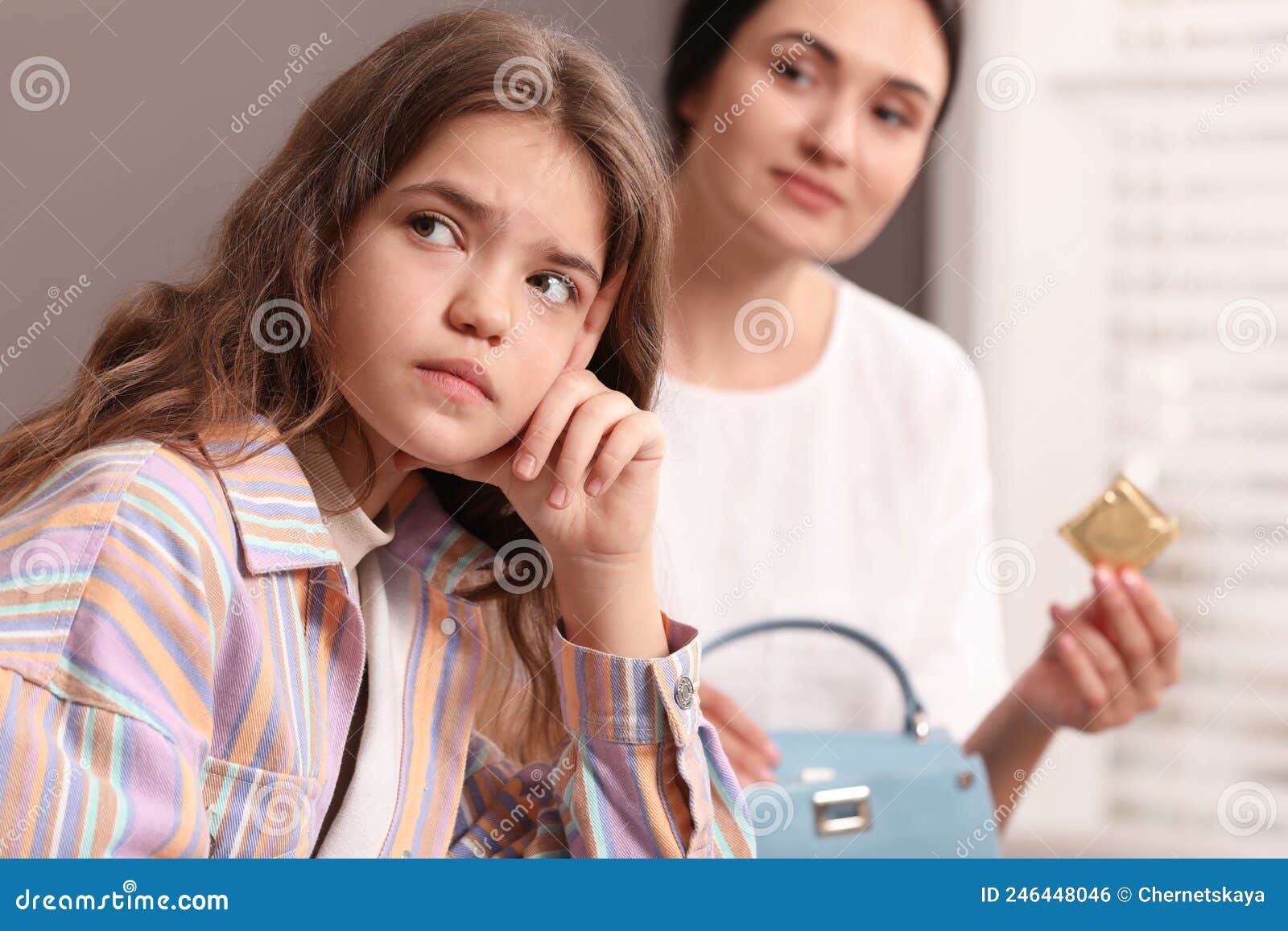 Mother Putting Condom Into Daughter`s Bag At Home Sex Education