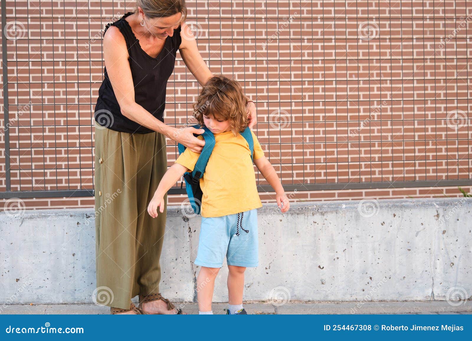 Mother Putting Her Child S Backpack on before Going To School. Stock ...