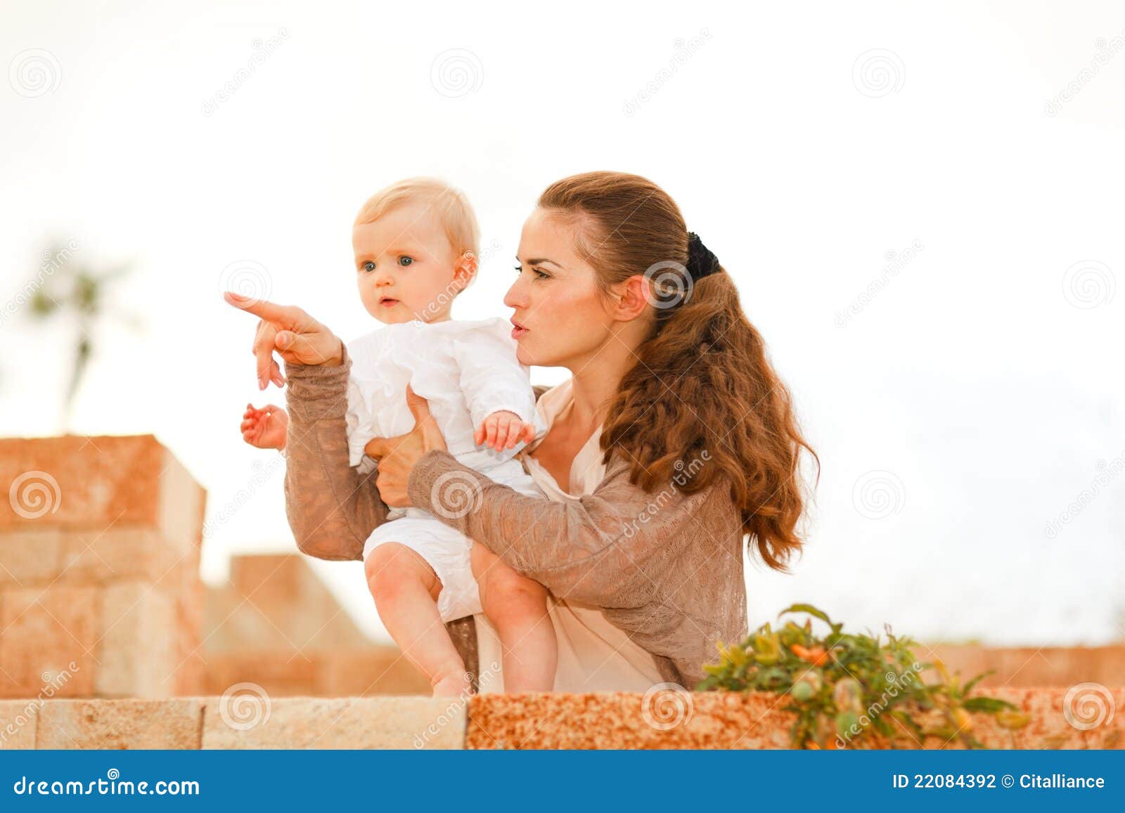 Mother Showing Something Her Interested Baby Stock Photo - Image of ...