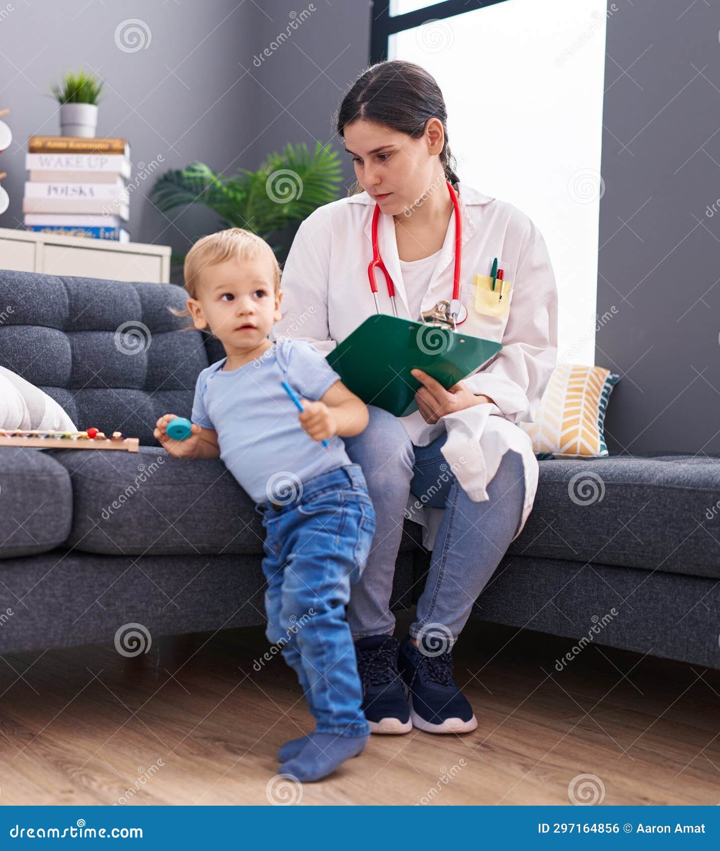 Mother and Son Doctor Writing on Document Examining Child at Home Stock ...