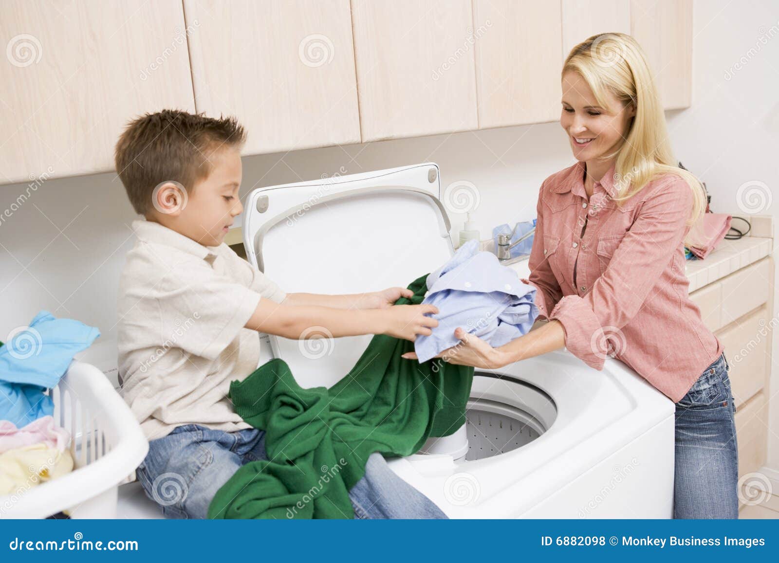 Mother and Son Doing Laundry Stock Photo - Image of assistance, sitting ...