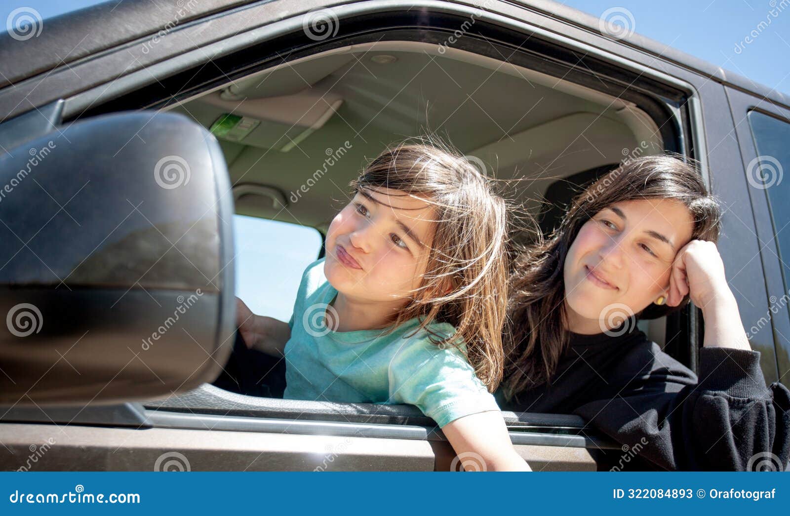 Mother and Son with Head Out the Van Window Look at Each Other in the ...