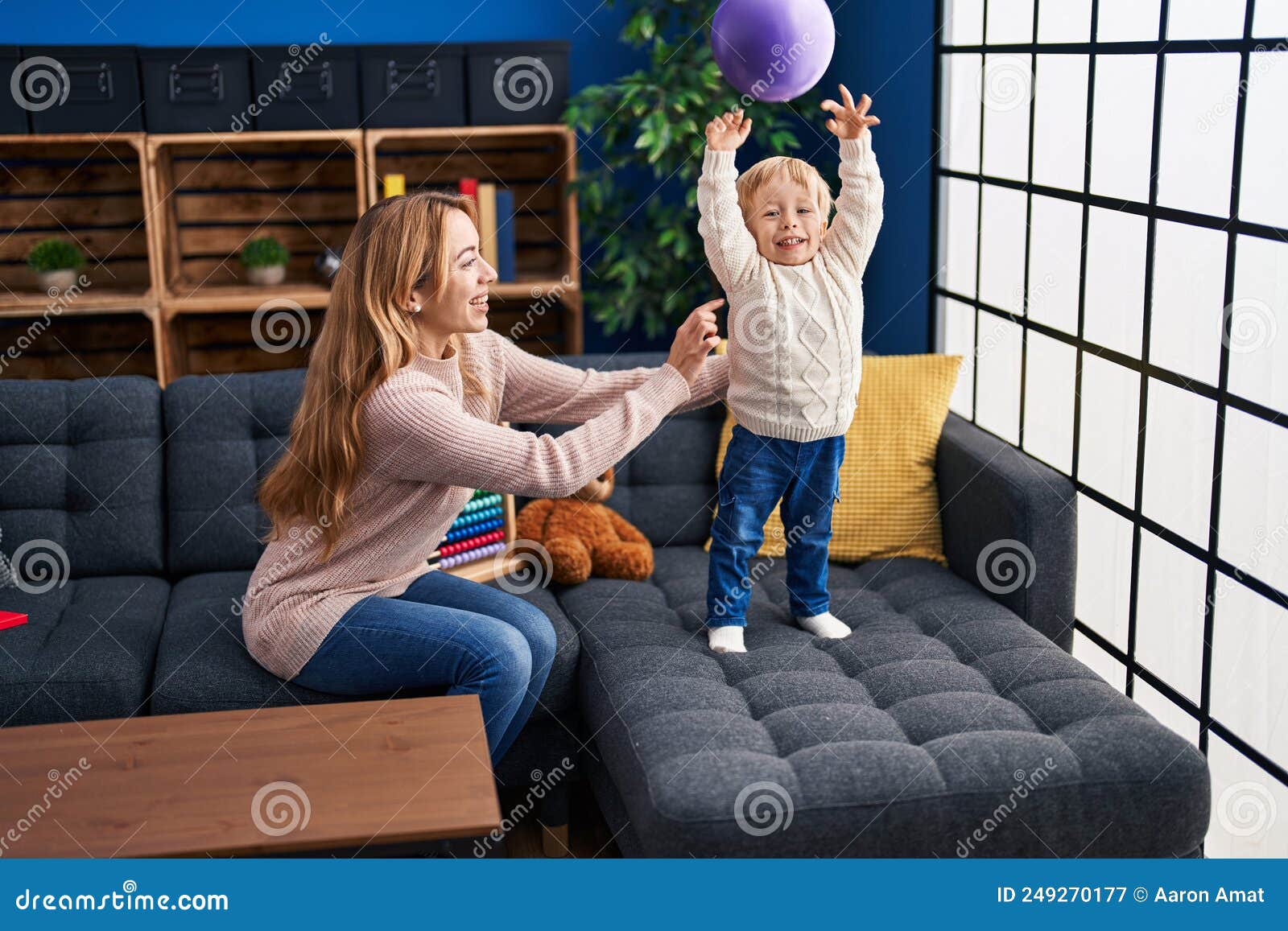 Mother and Son Playing with Ball Sitting on Sofa at Home Stock Image ...