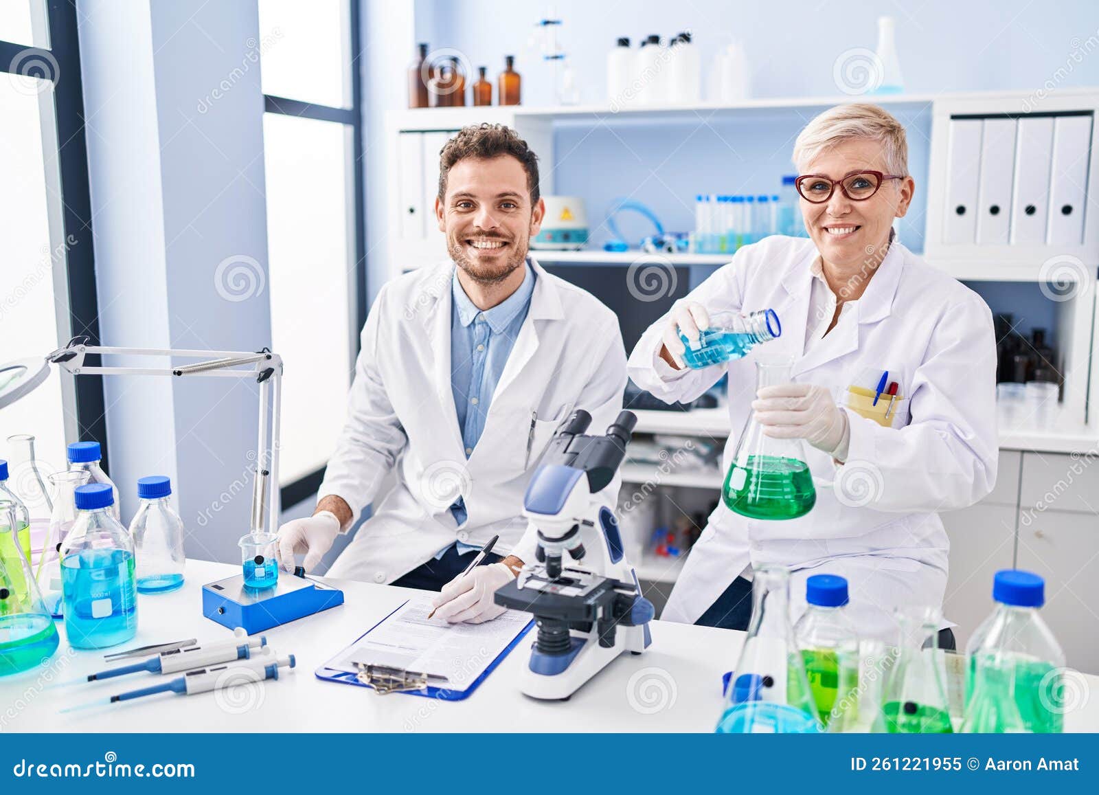 Mother and Son Scientist Partners Measuring Liquid at Laboratory Stock ...