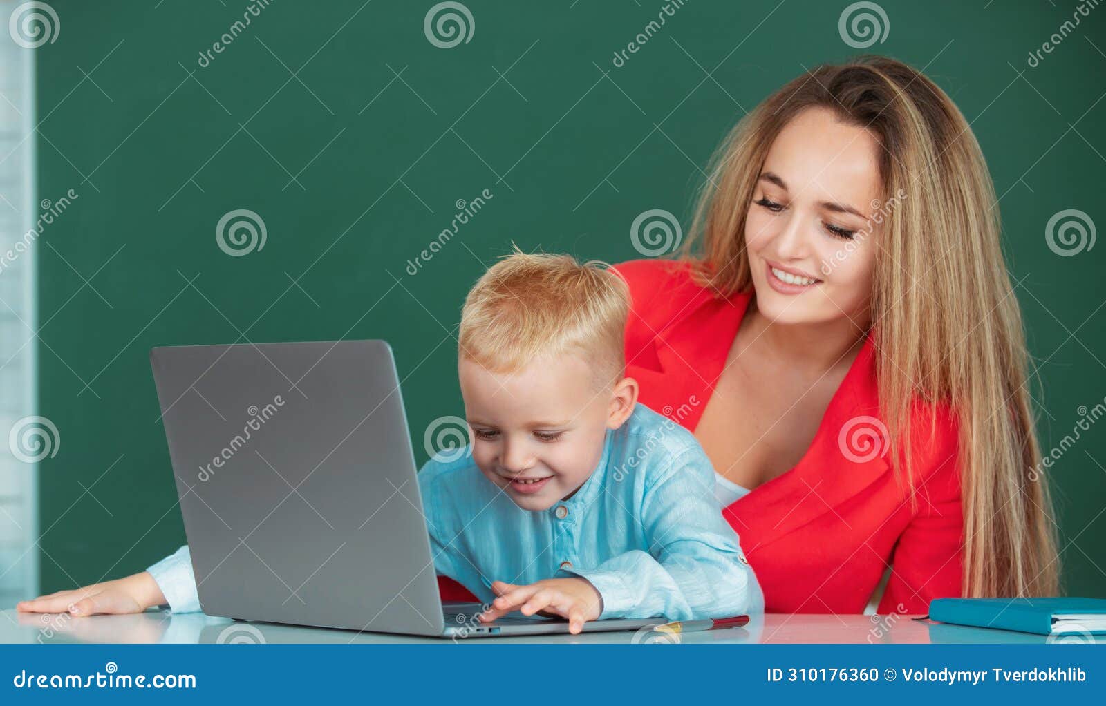 Mother and Son Together Using Computer Laptop. Teacher Explains Lesson ...