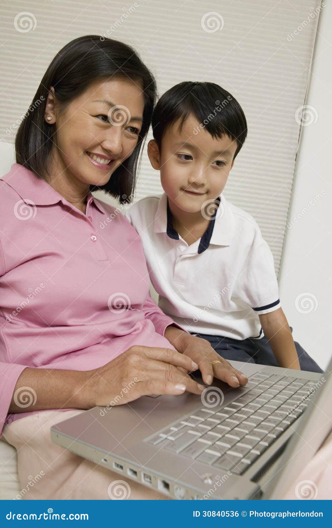 Mother and Son Using Laptop in Living Room Stock Photo - Image of ...