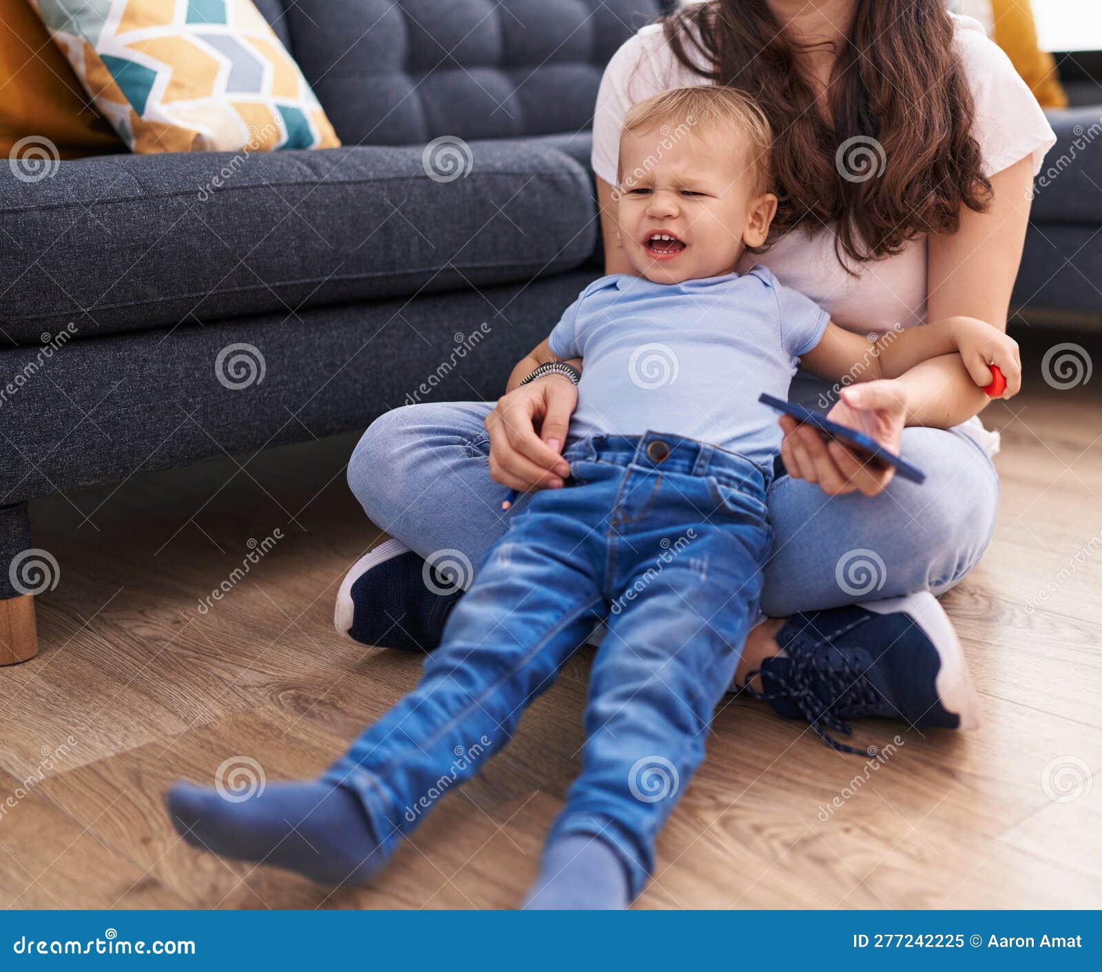 Mother and Son Using Smartphone Crying on Floor at Home Stock Image ...