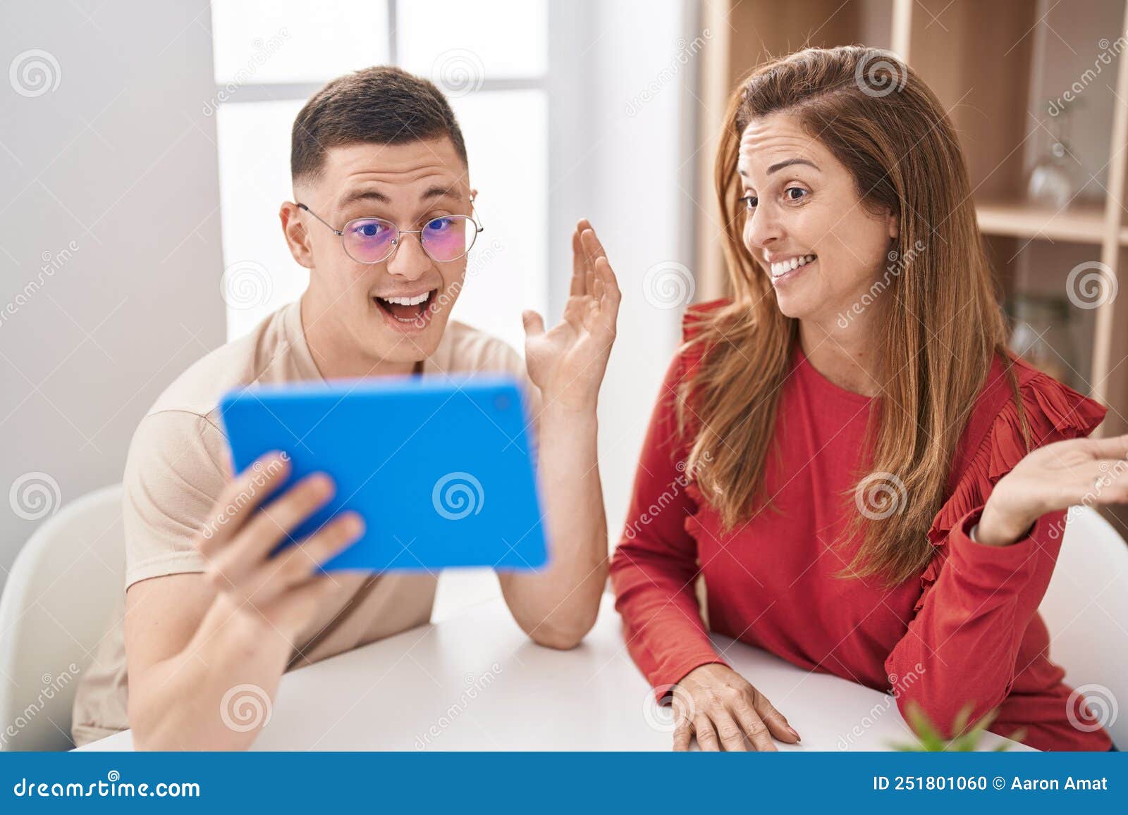 Mother and Son Using Touchpad Device Celebrating Achievement with Happy ...
