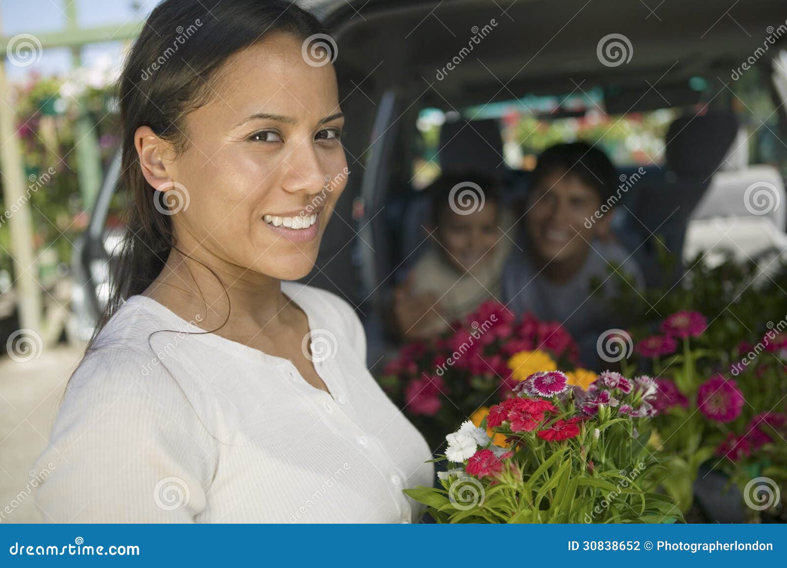 Mother Standing by Back of Minivan Holding Flowers Portrait Stock Photo ...