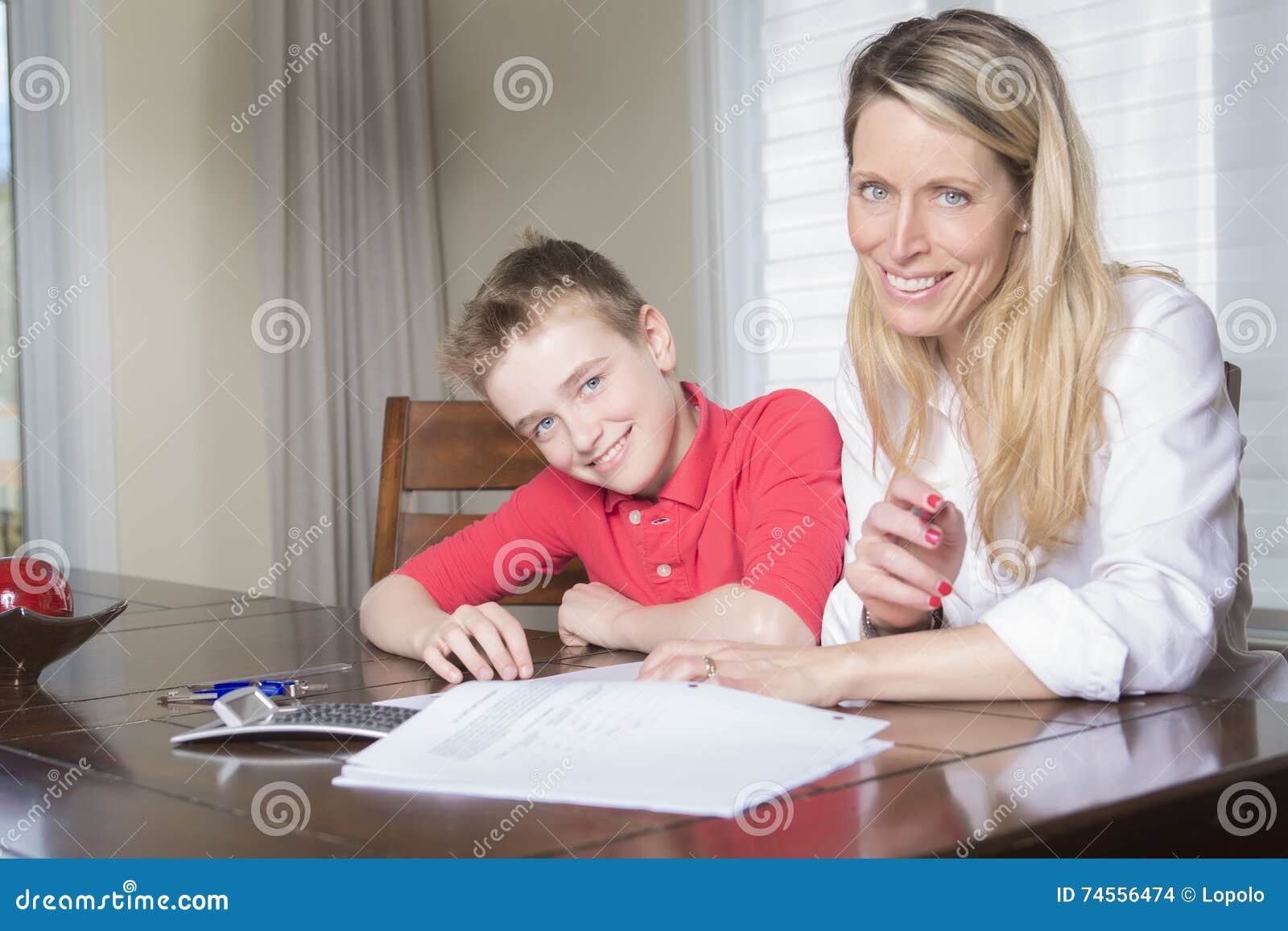 Mother at a Table Home Helping Her Small Son with His Homework Stock ...