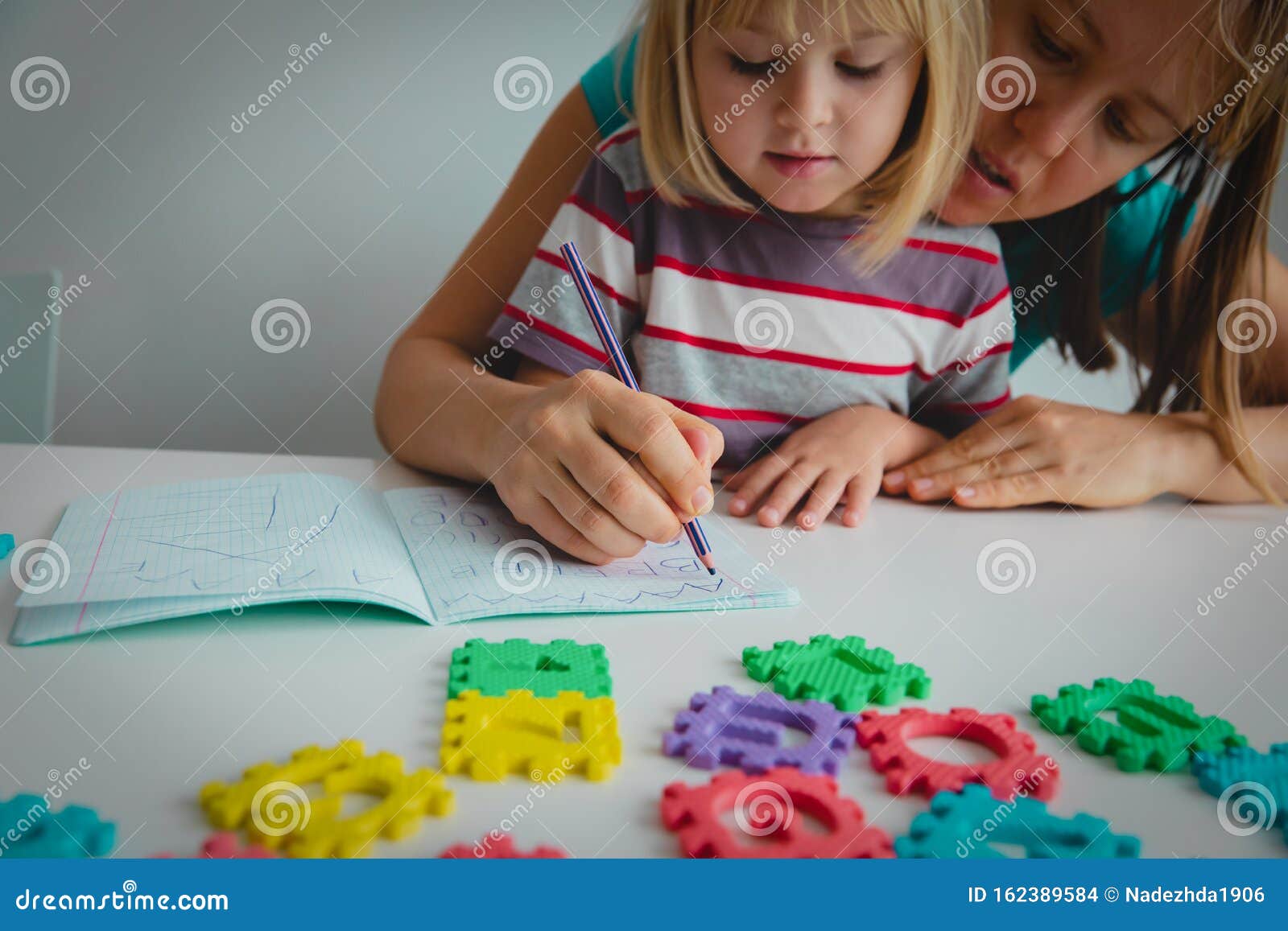 Mother Teaching Daughter How To Write Letters Royalty-Free Stock Image ...
