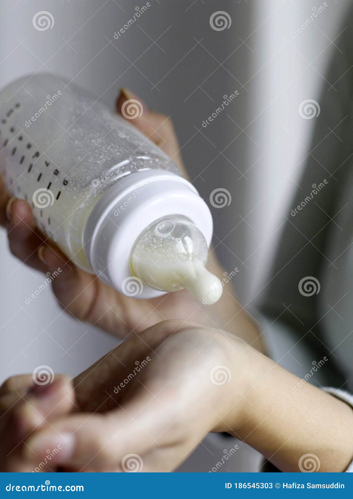 Mother Testing Milk Temperature. Conceptual Image Stock Image - Image ...