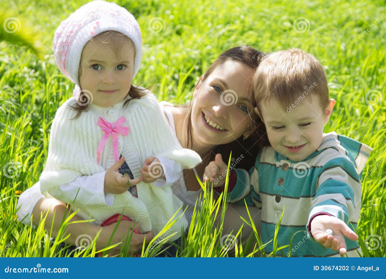 Mother with Two Children among Green Grass Stock Photo - Image of park ...