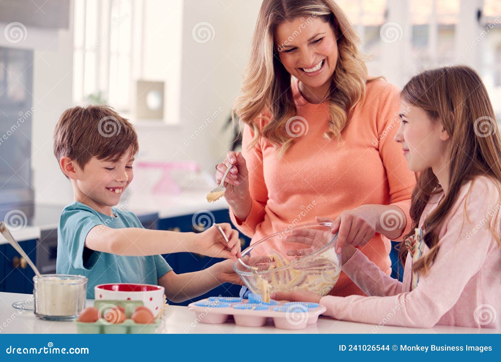 Mother with Two Children in Kitchen at Home Having Fun Baking Cakes ...